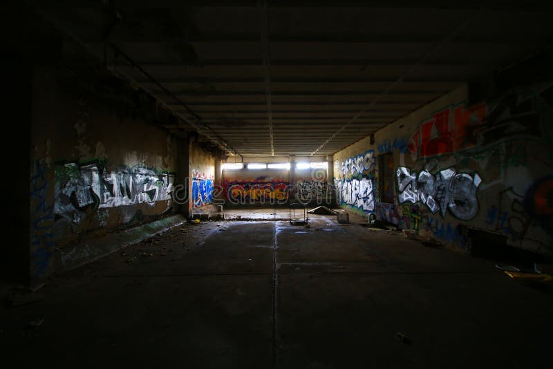 Graffiti-covered Walls Inside a Dark, Abandoned Warehouse with ...