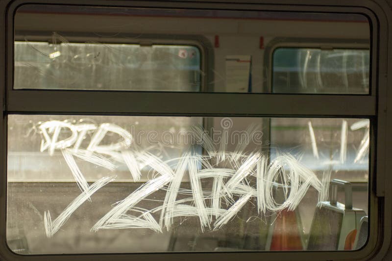 Graffiti Scrawled on the Glass of an Electric Train Backlit by a ...
