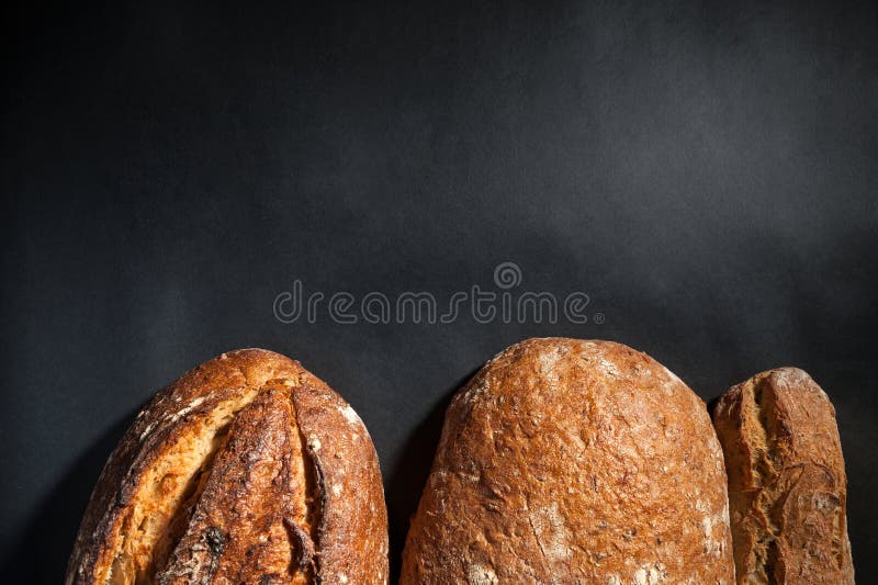 Grain bread on dark stock image. Image of grain, baked - 140769015