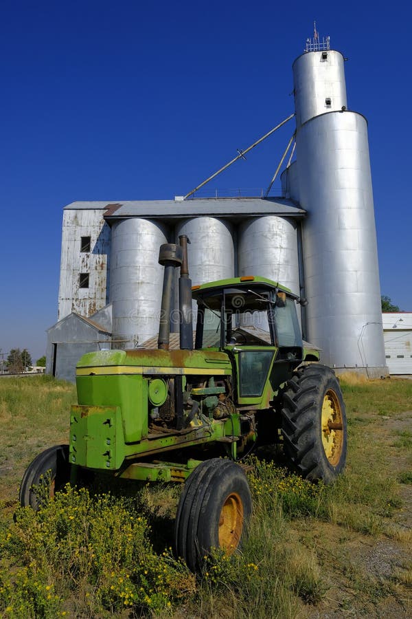 Grain Elevator Silo with Old Green Tractor Stock Image - Image of ...