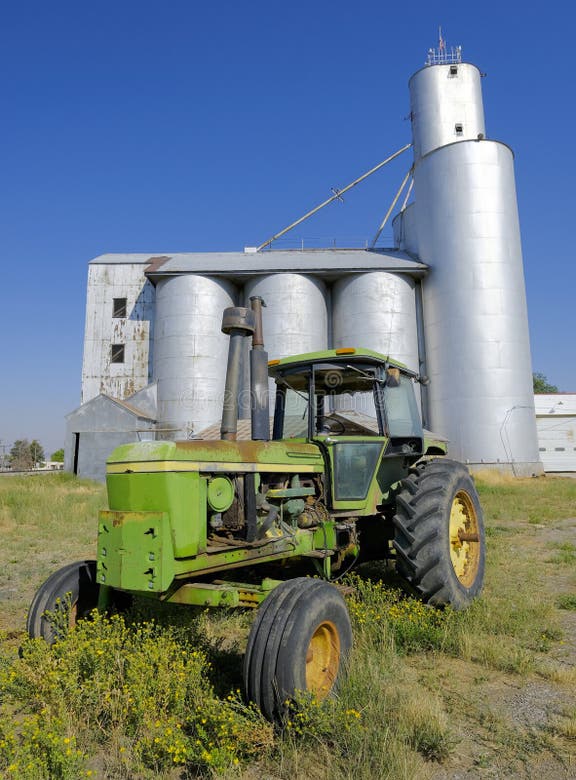 Grain Elevator Silo with Old Green Tractor Stock Image - Image of ...