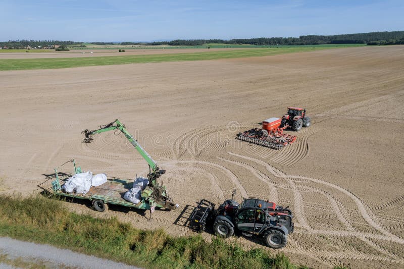 Grain Loader and Tractor with Seeder in the Field. Sowing Grain Using ...