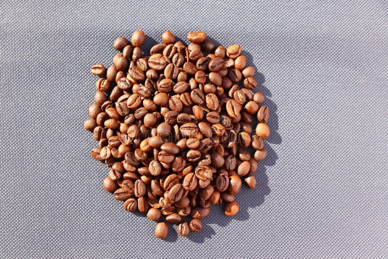 Grains of Aromatic Roasted Coffee Scattered on a Cardboard Surface in ...