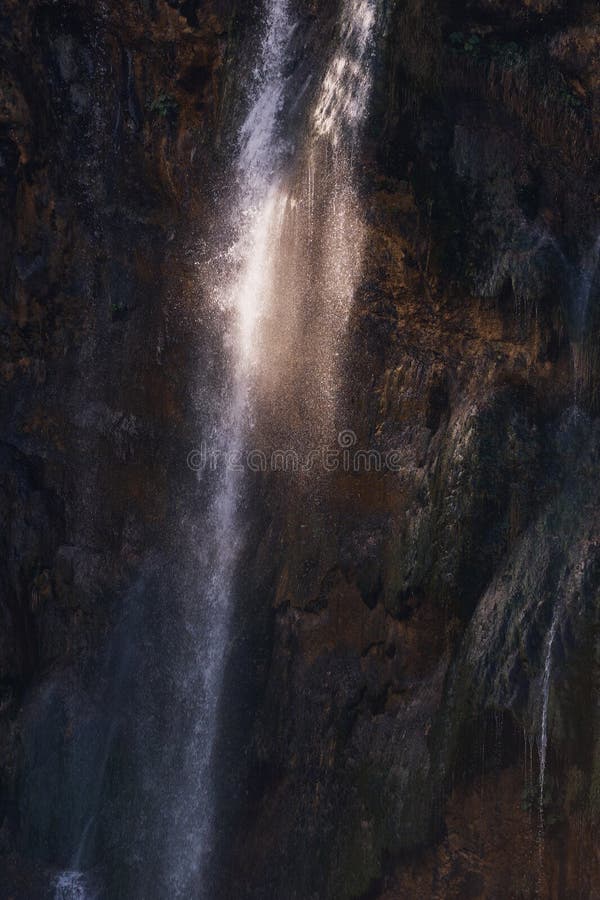 A Large Waterfall Running Down the Side of a Cliff Face Stock Image ...