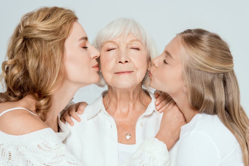 Granddaughter And Mother Kissing Grandmother With Stock Image Image