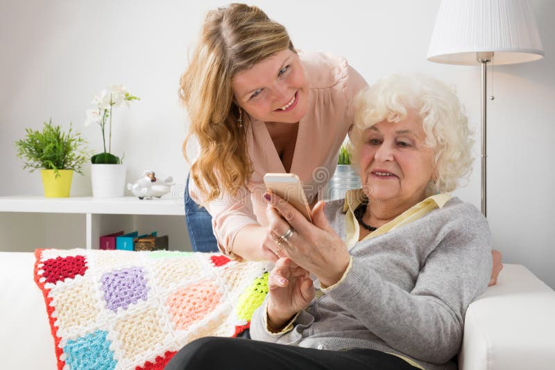 Granddaughter Teaching Grandma How To Usemodern Cell Phone Stock Image ...