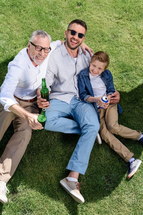 Grandfather, Father and Son Drinking Beer and Soda while Hugging Stock ...