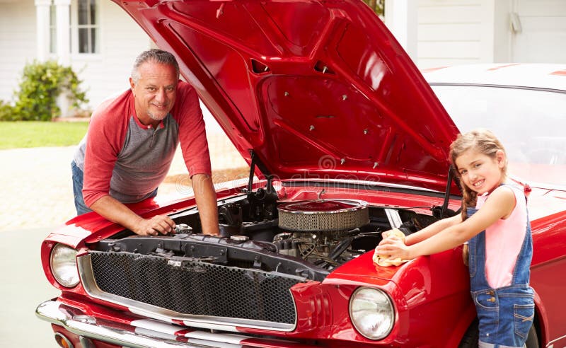 Grandfather and Granddaughter Working on Classic Car Stock Photo ...