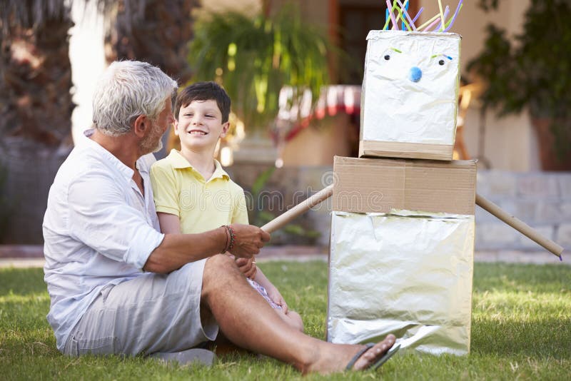 Grandfather and Grandson Building Model Robot in Garden Stock Photo ...