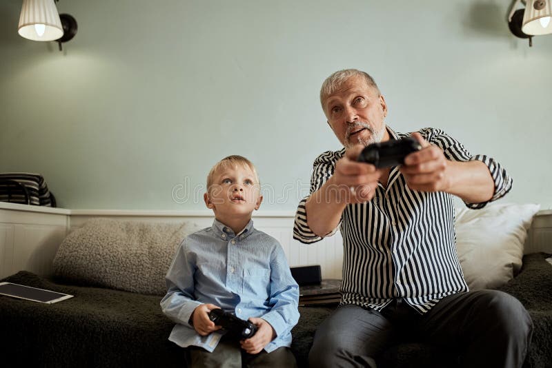 Grandfather and Grandson Playing Video Games on Computer with Joystick ...
