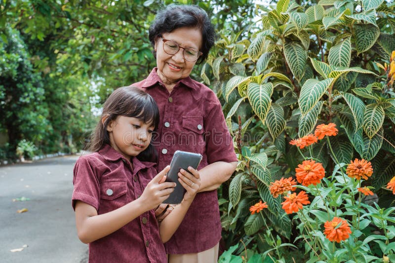 Grandma and Granddaughter Using a Smartphone Stock Image - Image of ...