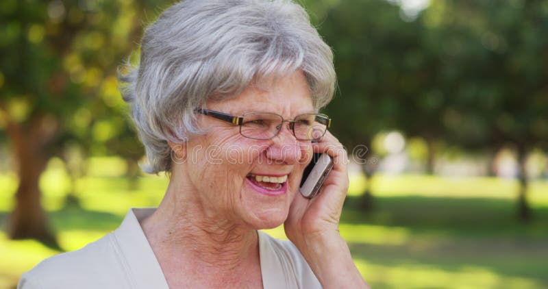 Grandma Talking on Her Smartphone at the Park Stock Video - Video of ...