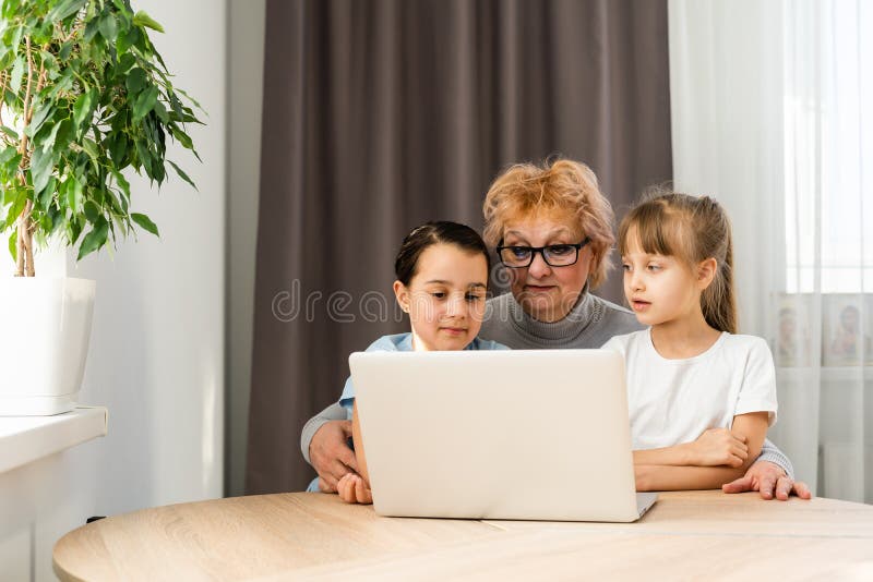 Grandmother with Granddaughters Use a Computer Stock Photo - Image of ...