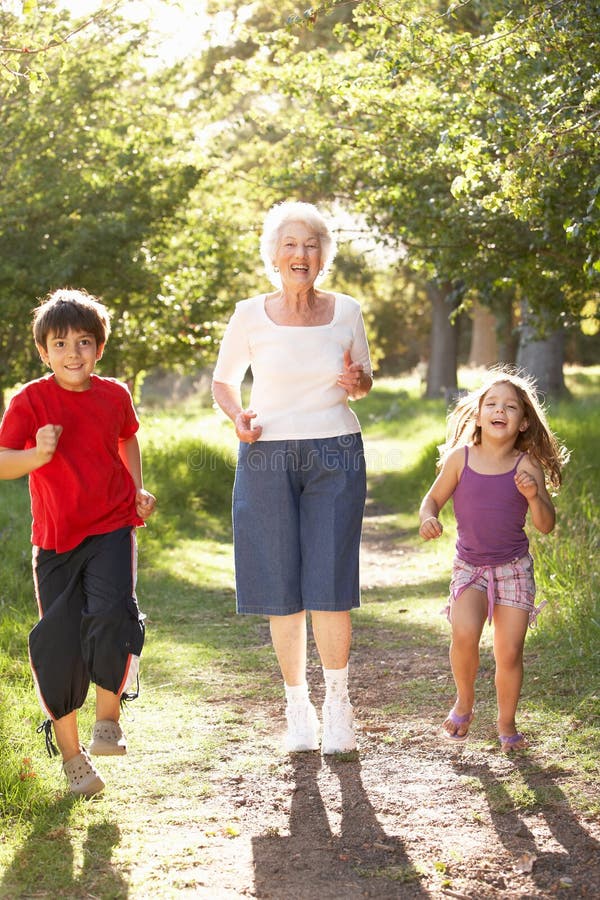 Grandmother Jogging in Park with Grandchildren Stock Image - Image of ...