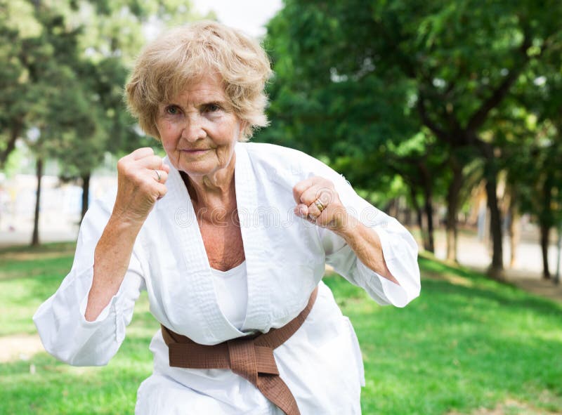 Grandmother in Kimono Training Karate in Summer Park Stock Photo ...