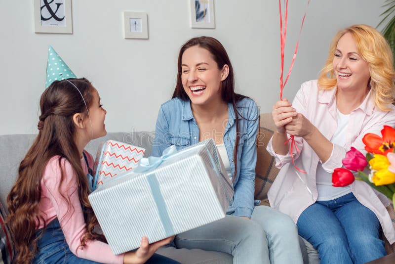 Grandmother Mother And Daughter Together At Home Birthday Sitting Girl