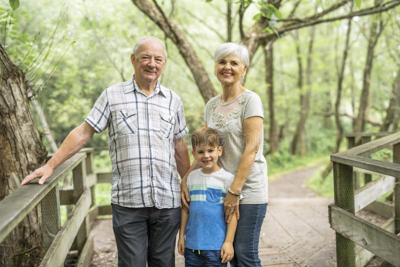 Grandparents with Grandkid on Summer Forest Having Great Time Stock ...