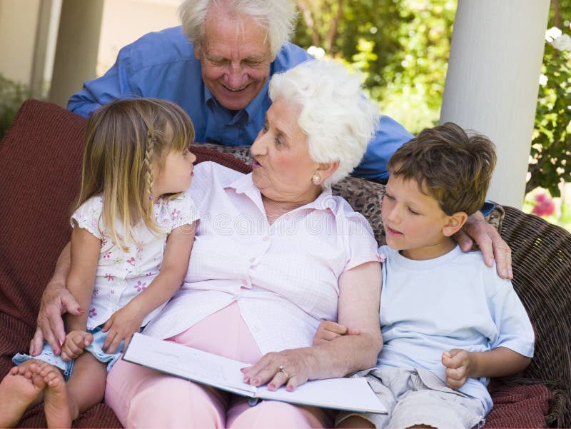 Grandparents Reading To Grandchildren Stock Photo - Image of grandson ...