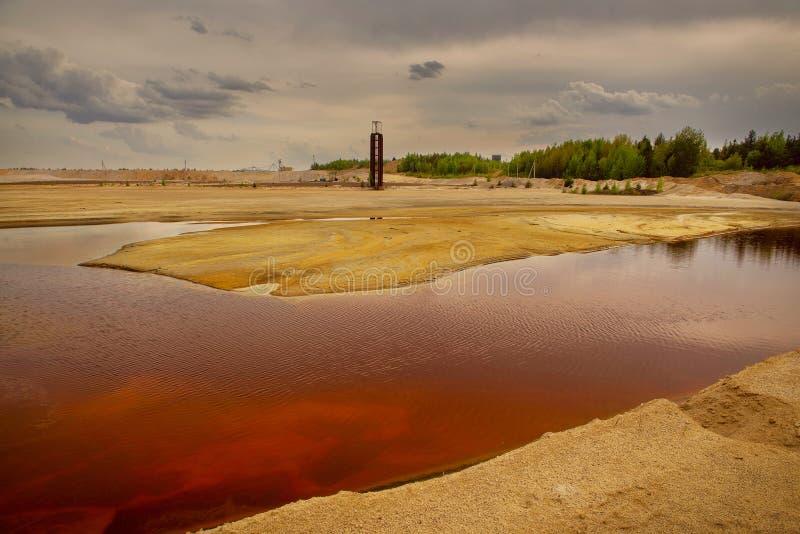 Granite Quarry for Iron Ore Extraction. Pond with Red Water after ...