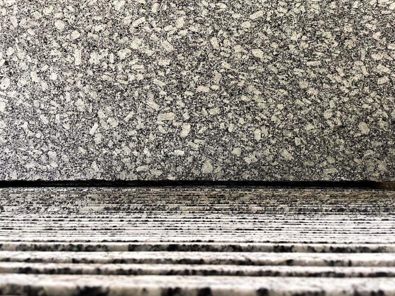 A Granite Slab Displayed on Vertically Stacked Granite Slabs in a ...