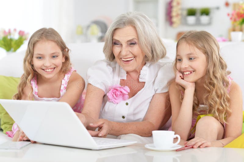 Granny with Granddaughters Using Laptop Stock Image - Image of computer ...