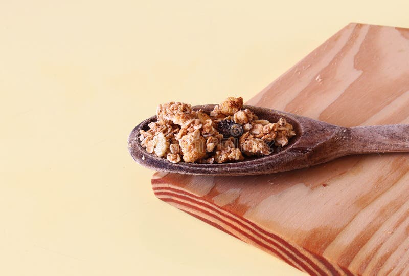 Granola on a Wooden Spoon. Breakfast Cereal on the Cutting Board. Stock ...