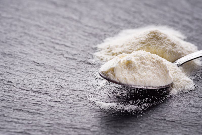 Granulated Milk Powder on a Dark Stone Background Stock Photo - Image ...