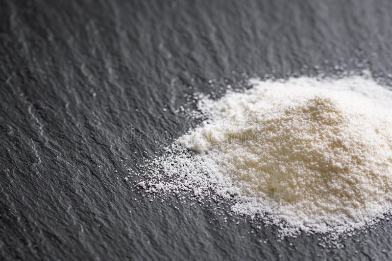 Granulated Milk Powder on a Dark Stone Background Stock Photo - Image ...