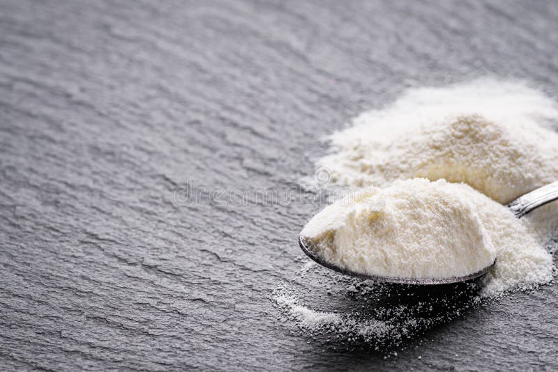 Granulated Milk Powder on a Dark Stone Background Stock Photo - Image ...