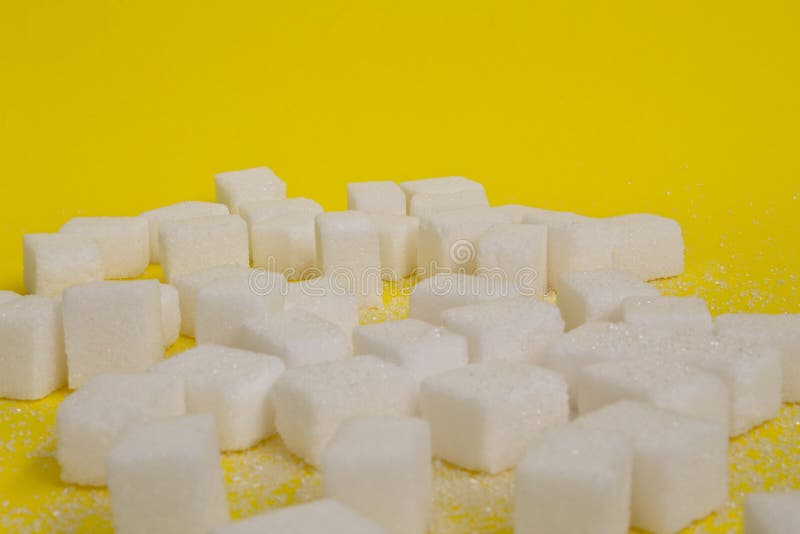 Granulated and Sugar Cubes Isolated on Yellow Background. Stock Image ...
