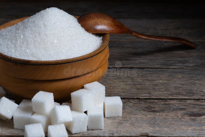 Granulated Sugar in a Wooden Cup, a Scattering of Refined Sugar Cubes ...