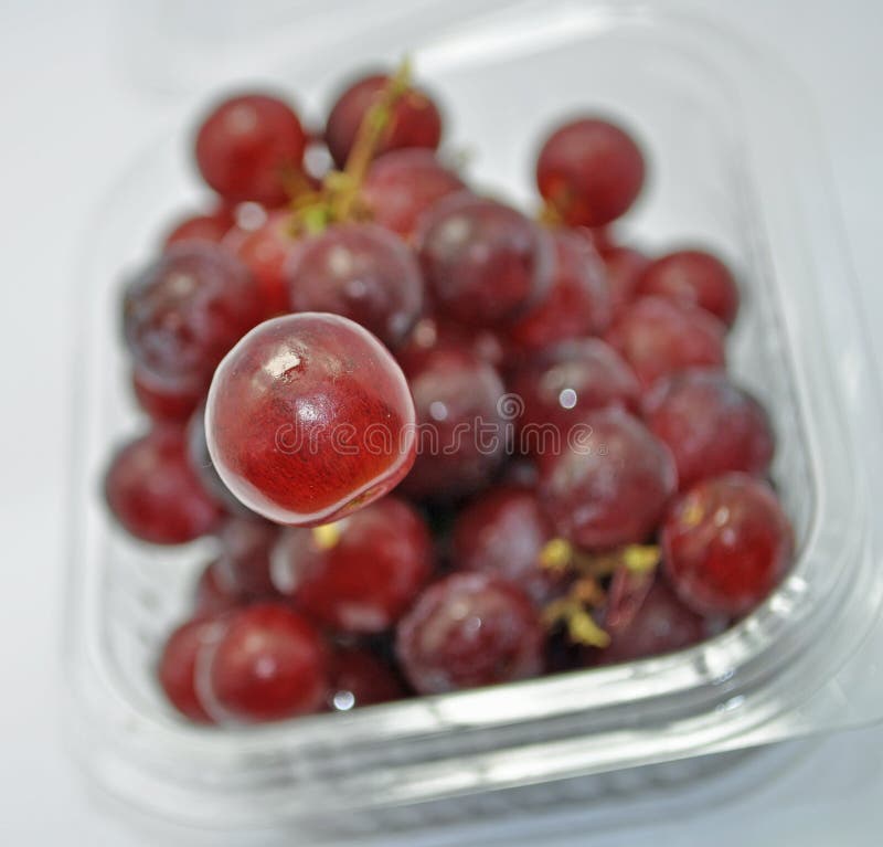 Grape Floating Up from Retail Package Stock Photo - Image of bunch ...