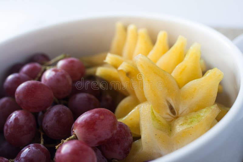 Grape and Starfruit in a Bowl Stock Photo - Image of yellow, green ...
