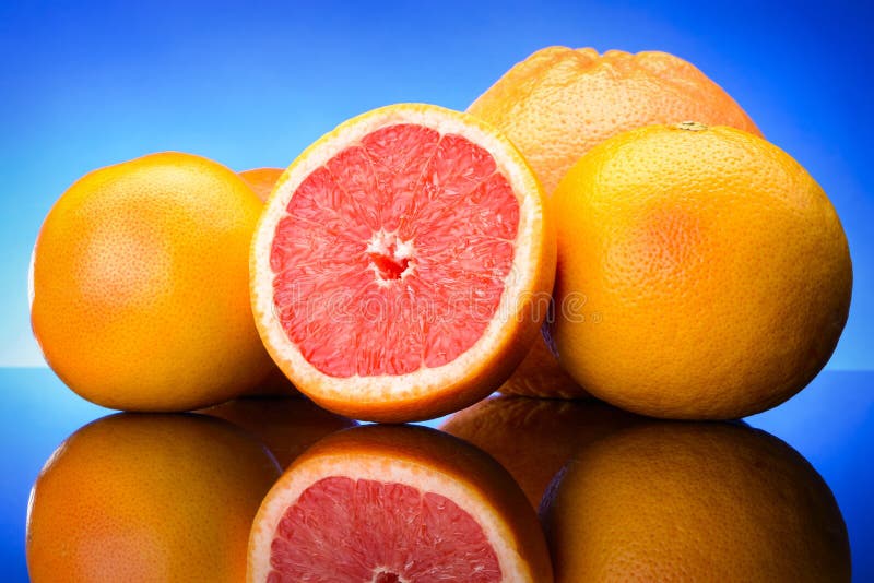 Grapefruit Fruits on a Blue Background Stock Photo - Image of cold ...