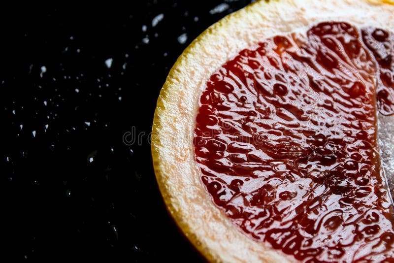 Grapefruit Pulp with Drops of Moisture on a Black Mirror Stock Photo ...