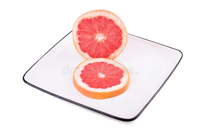 Grapefruit in square plate stock image. Image of isolated - 128265475