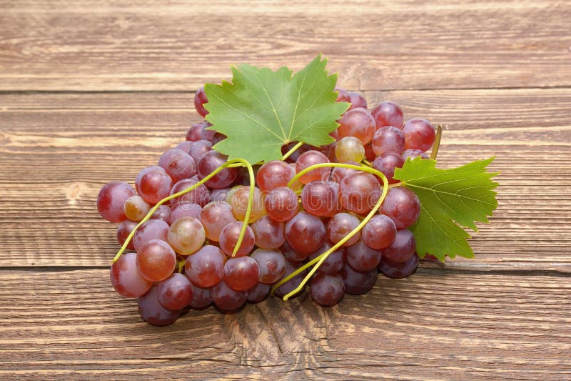 Grapes on a wooden table stock photo. Image of color - 71430220
