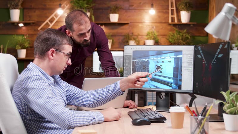 Graphic Desginer Working in Gaming Industry Showing His Assitant the ...