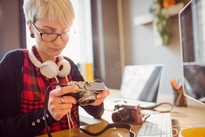 Graphic Designer Looking at Pictures in Digital Camera Stock Image ...