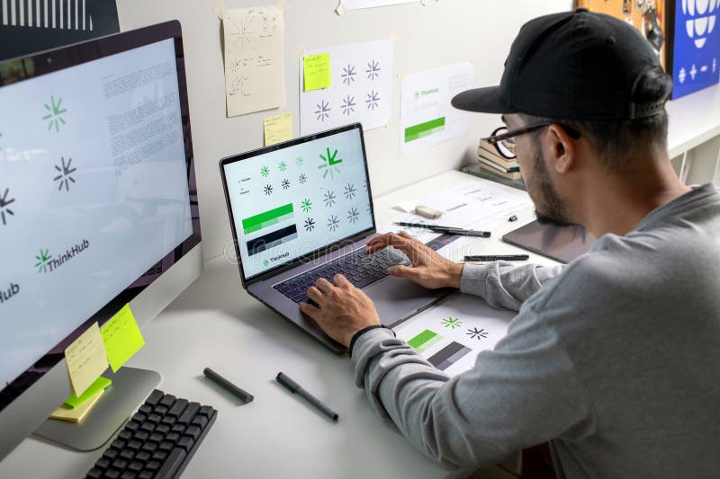 Graphic Designer Making Notes on Logo Designs, Designing Logos, and ...