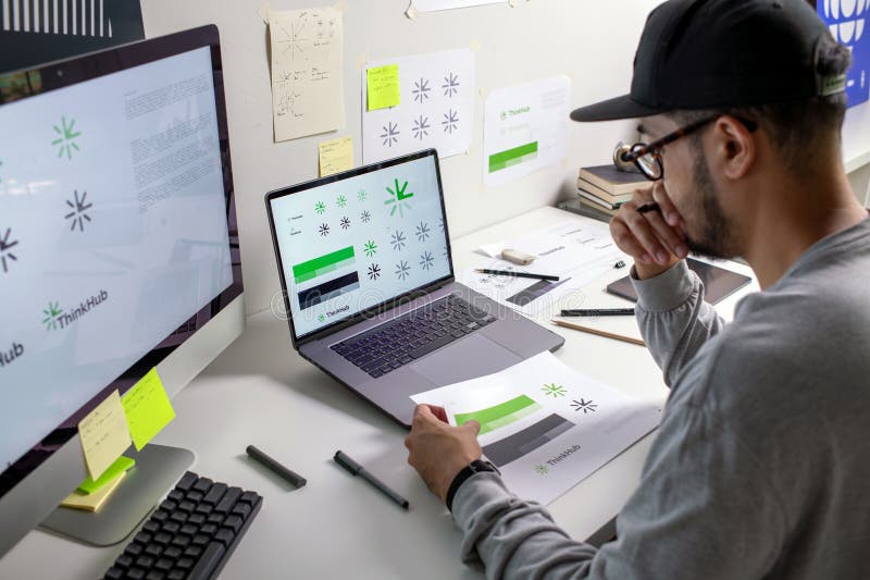 Graphic Designer Making Notes on Logo Designs, Designing Logos, and ...