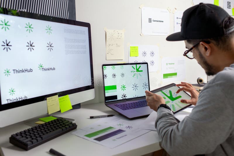 Graphic Designer Making Notes on Logo Designs, Designing Logos, and ...