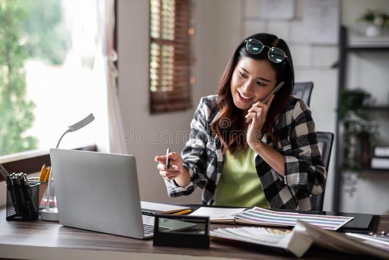 Graphic Designer Talk about Work with Mobile Phone at Office Stock ...