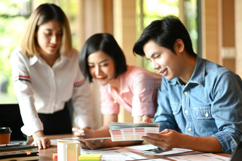 Graphic Designer Team is Working in the Office. they Use Laptop and ...