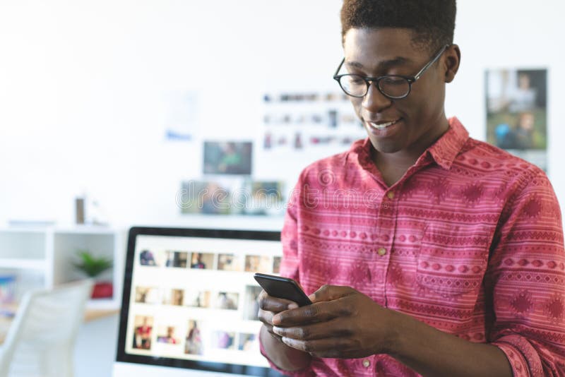 Graphic Designer Using Mobile Phone at Desk in Office Stock Image ...