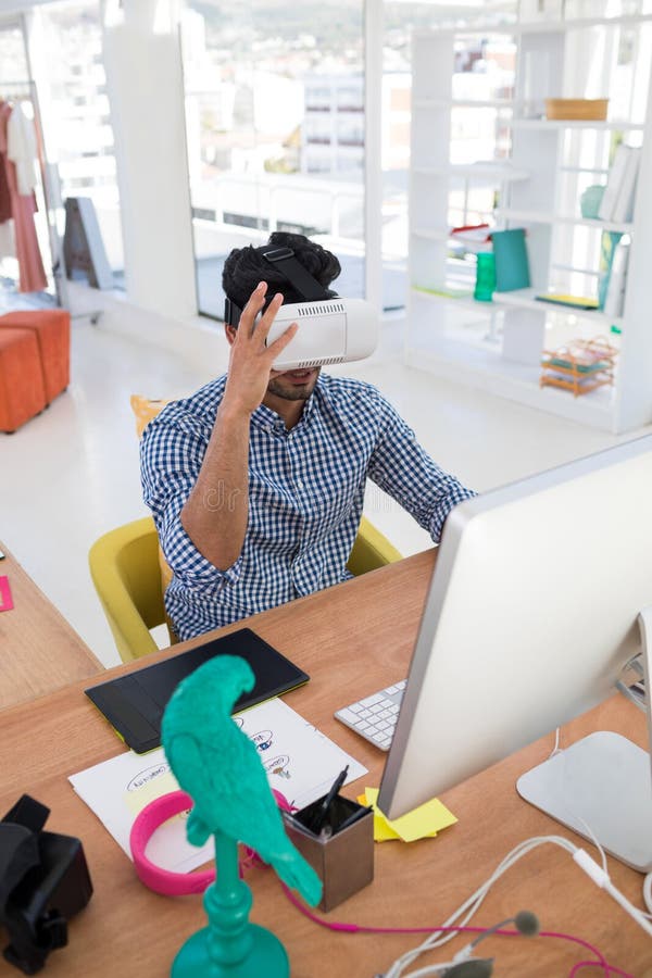 Graphic Designer in Virtual Reality Headset Working on Computer at Desk ...