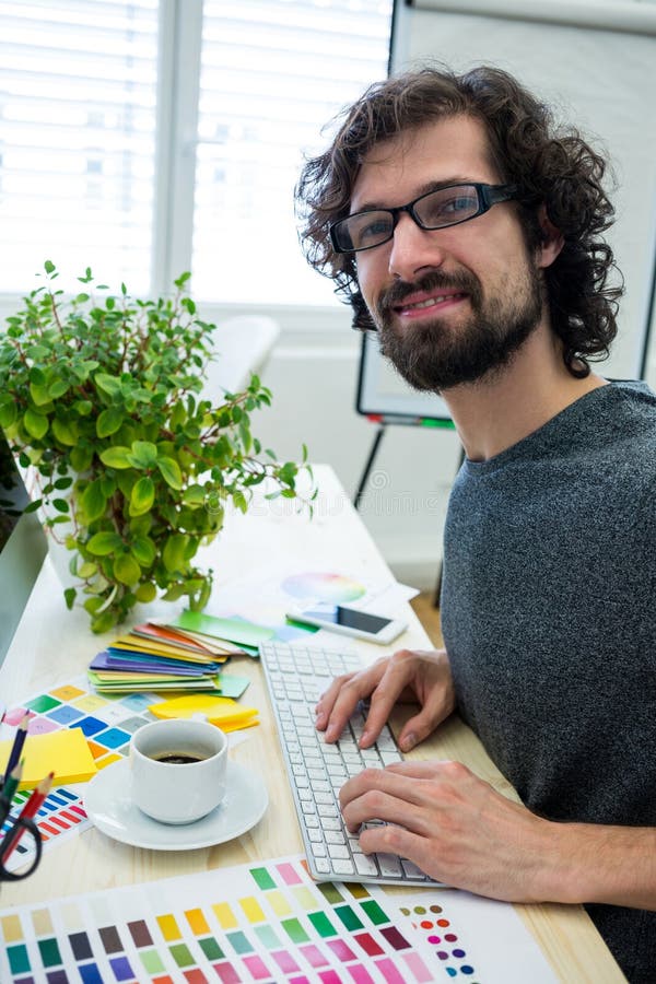 Graphic Designer Working on Computer at His Desk Stock Photo - Image of ...