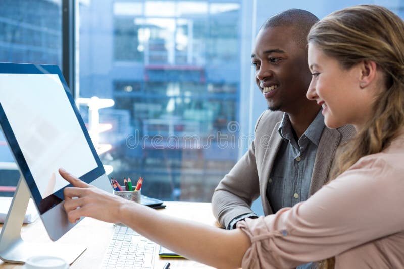 Graphic Designer Working at Desk with Colleague Stock Photo - Image of ...