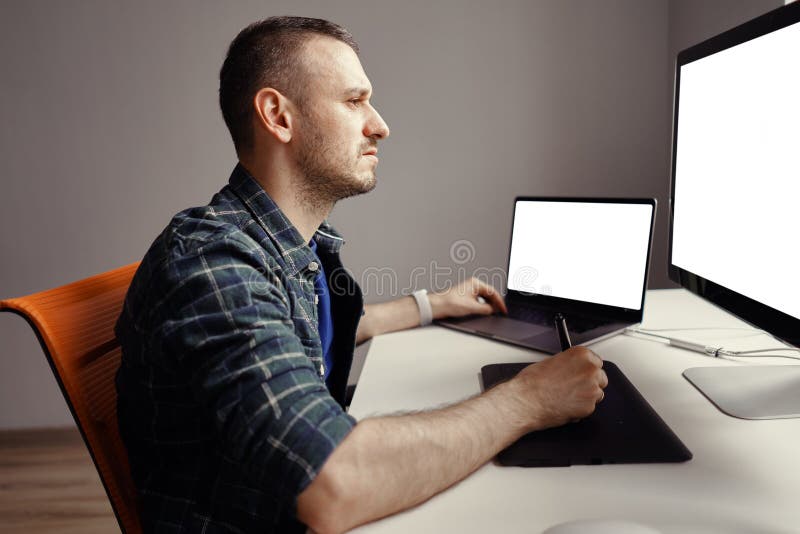 Young Man Working with Interactive Pen Display and Computer Stock Photo ...