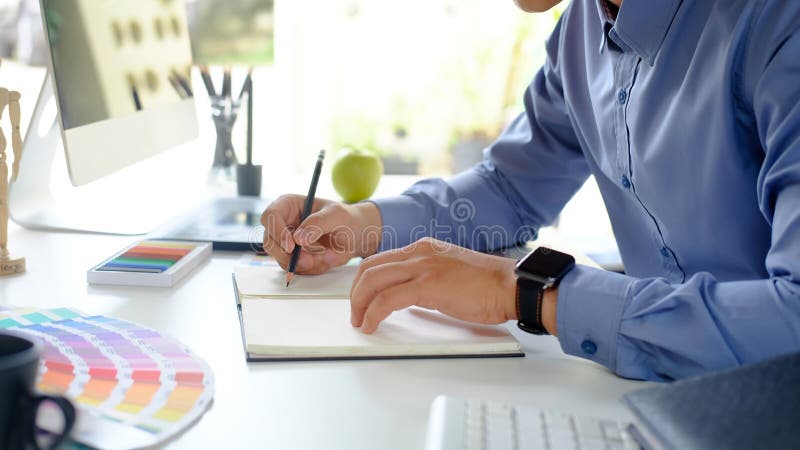 Graphic Designer Working with Notebook Paper and Computer on Desk Stock ...